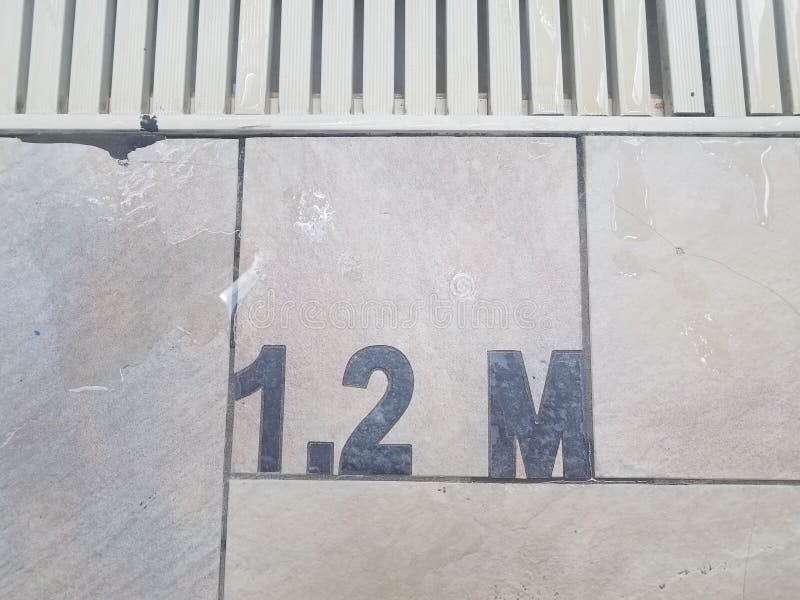 One Point Two Meters Sign and Drain and Water at Side of Pool Stock ...