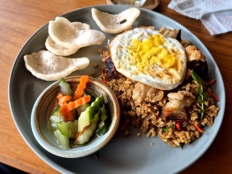 One Portion of Fried Rice with Fried Egg, Crackers, and Pickled ...