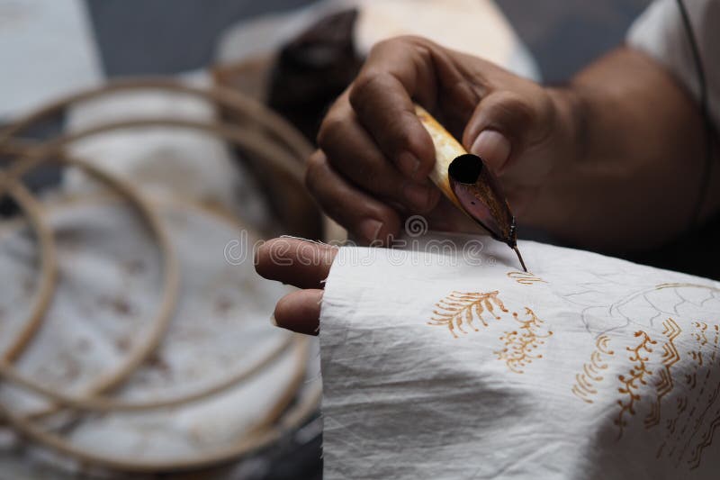 A Man is Drawing a Batik Pattern on Fabric Stock Image - Image of ...
