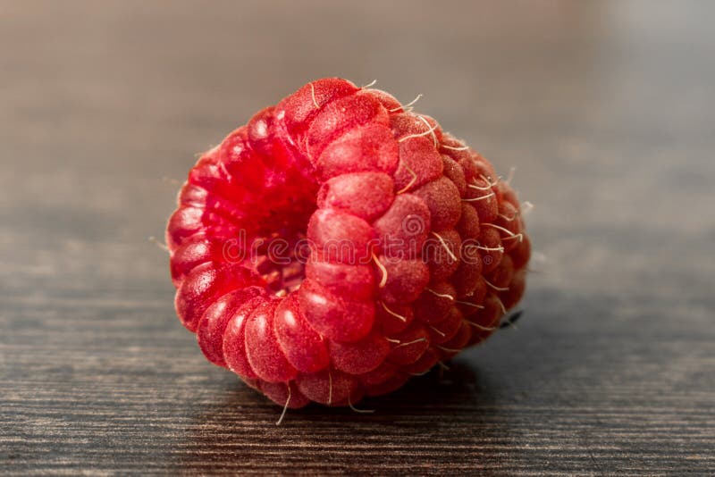 One Raspberry on a Wooden Background. Berries Concept, Side View Stock ...