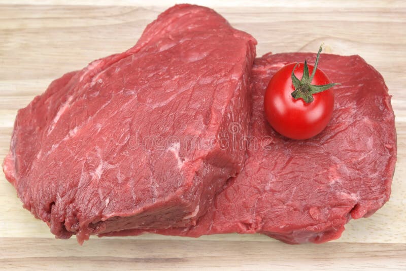 One Raw Beef Steak and Tomato Close-Up Stock Photo - Image of kitchen ...