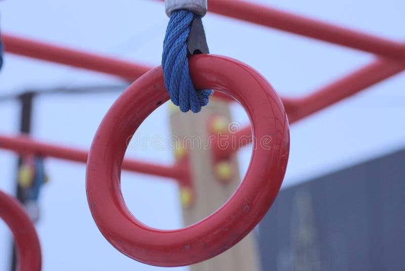 One Red Metal Sports Ring Hangs on a Blue Iron Cable Stock Image ...
