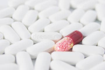 One Red Pill in Many White Pills Stock Image - Image of drop ...