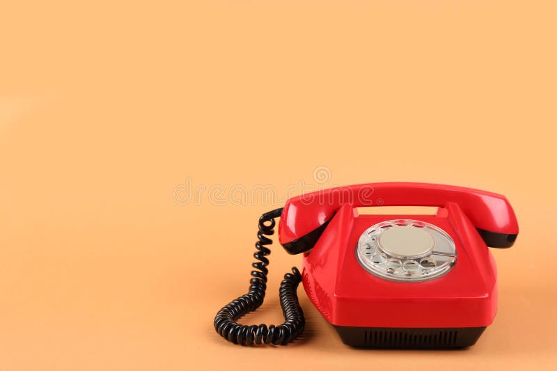 One Red Telephone with Handset on Pale Orange Background, Space for ...