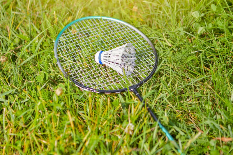 One Shuttlecock Along with Carbon Badminton Racket Placed on Lawn ...
