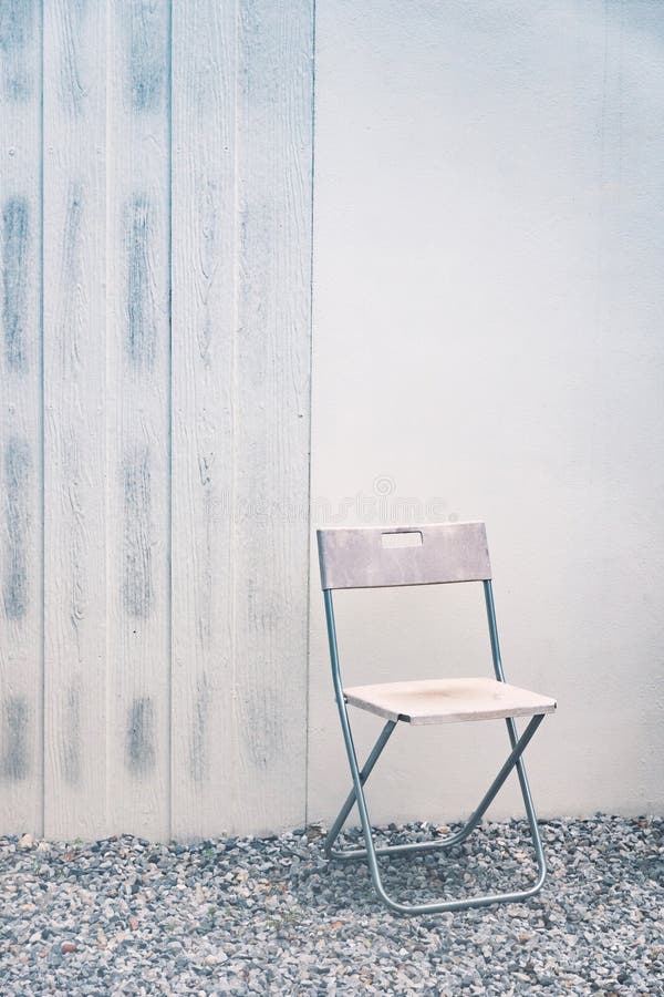 One Simple Chair with White Concrete Background in the Garden Stock ...