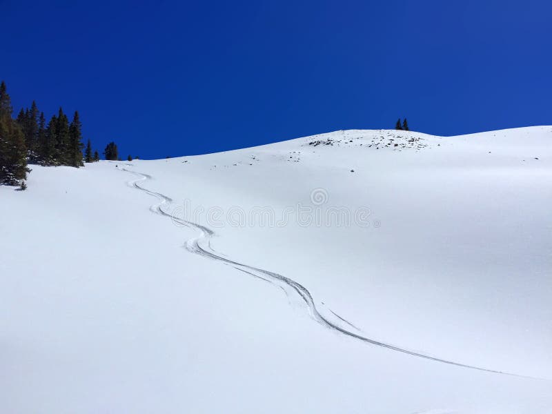 One Skied Snow Track on a Mountain with Clear Skies Stock Image - Image ...