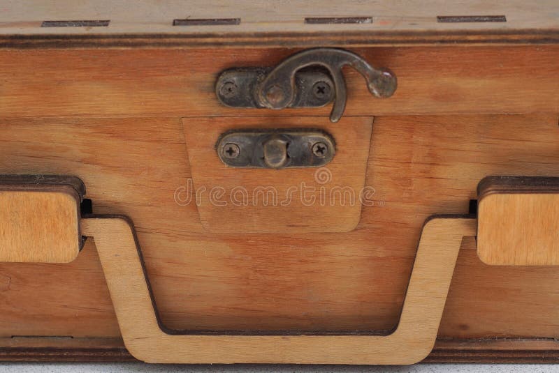 One Small Black Brass Latch with a Pattern on the Brown Wooden Board ...