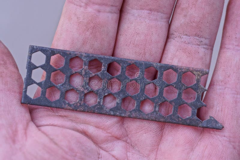 One Small Brown Rectangular Metal Plate with Holes Lies on Brown ...