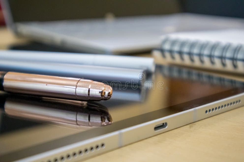 One Smart Pen and Two Normal Pen Over a Tablet Screen Stock Image ...