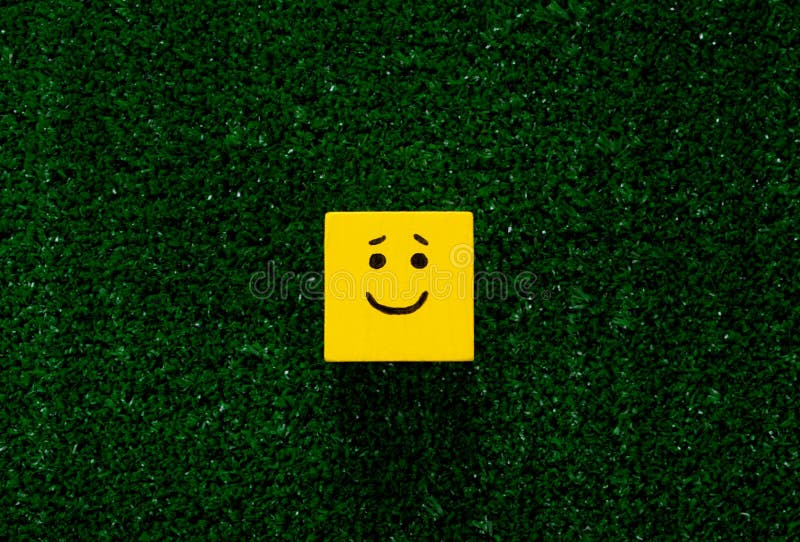 One Smiling Yellow Cube on the Artificial Grass Stock Image - Image of ...