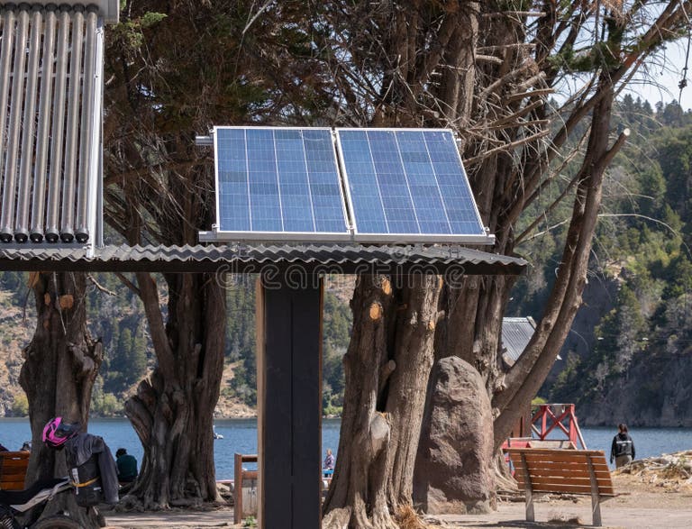 One Solar Panel in a Pole in the Middle of a Park with a Lake and Trees ...