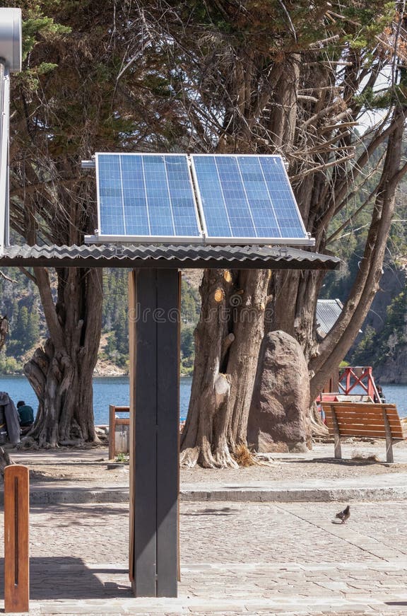One Solar Panel in a Pole in the Middle of a Park with a Lake and Trees ...