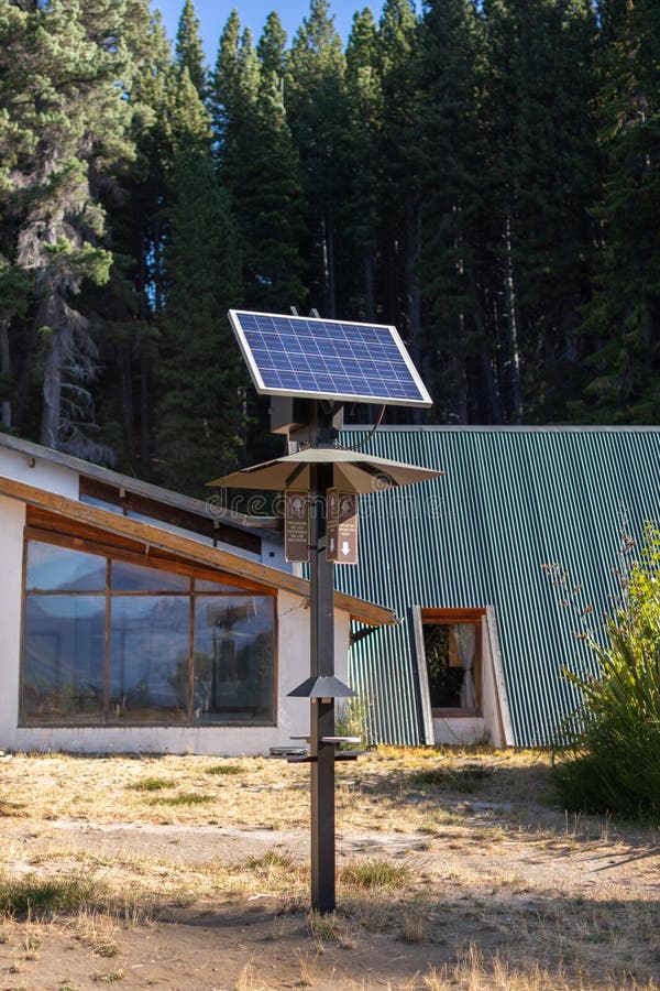 One Solar Panel in a Pole Near a Modern House in the Middle of a Forest ...
