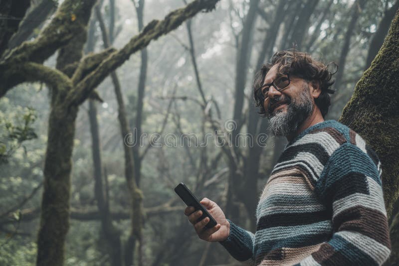 One Standing Man Alone in the Forest Woods Smiling and Using Mobile App ...