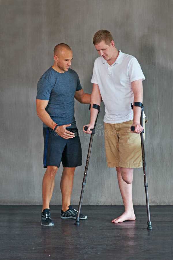 One Step at a Time. Studio Shot of a Young Amputee Training in a Gym ...