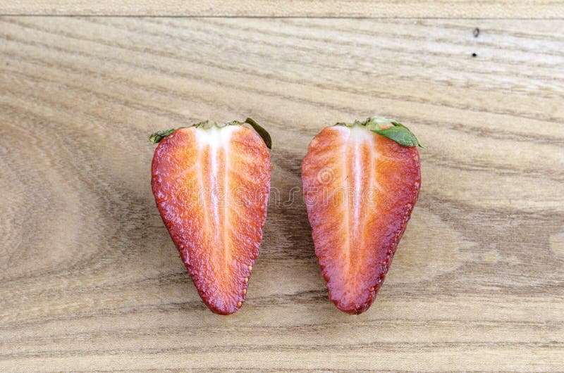 One Strawberry Cut Half Over Wood Stock Photos - Free & Royalty-Free ...