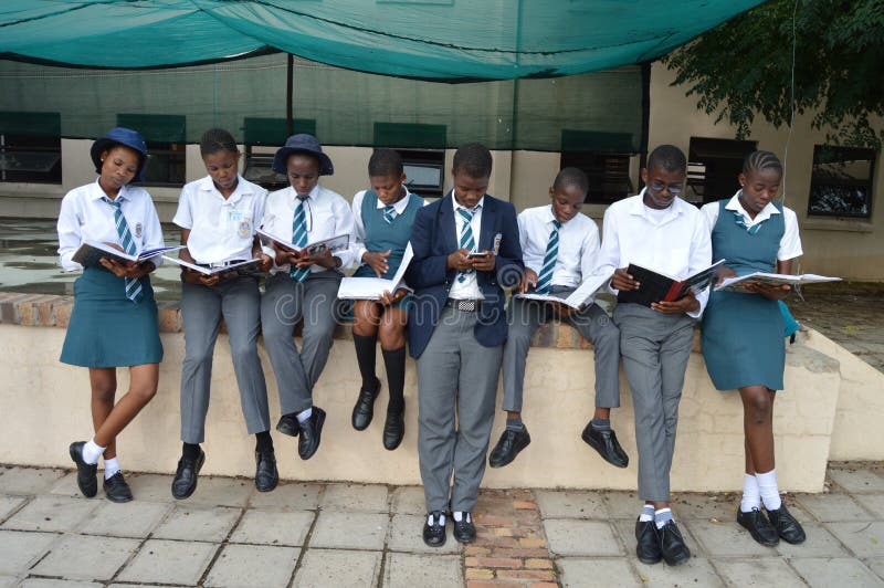 One Student Busy Texting among a Group of Studying Students Editorial ...