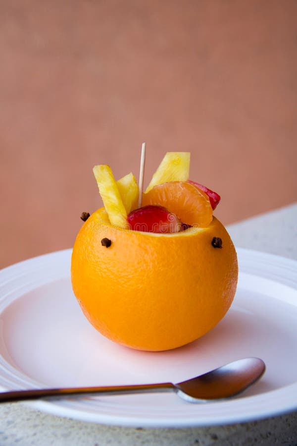One Stuffed Orange with Mixed Fruit Salad on a White Dish Stock Image ...