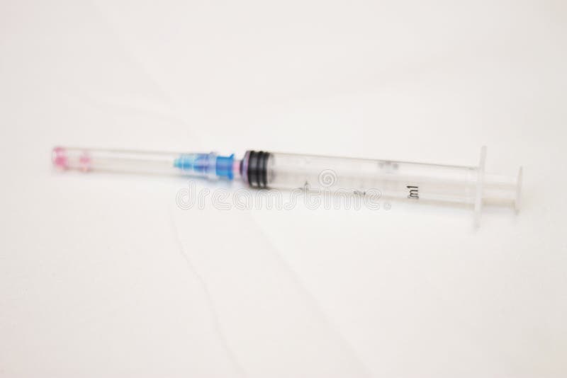 One Syringe with Cap and Needle after Using on the White Bckground ...