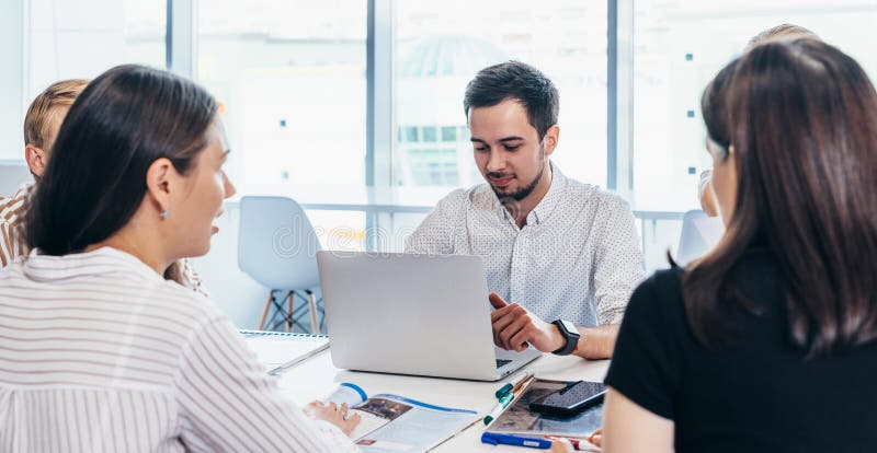 At One Table Man with Laptop Computer and His Employees Stock Photo ...