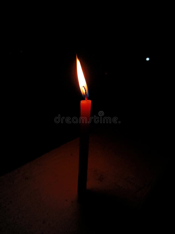 One Tall Lit Candle on a Dark Background Stock Photo - Image of tall ...