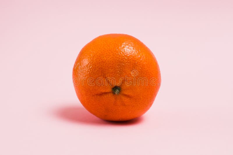 One Tangerine on a Pink Paper Background with Copy Space. Stock Photo ...