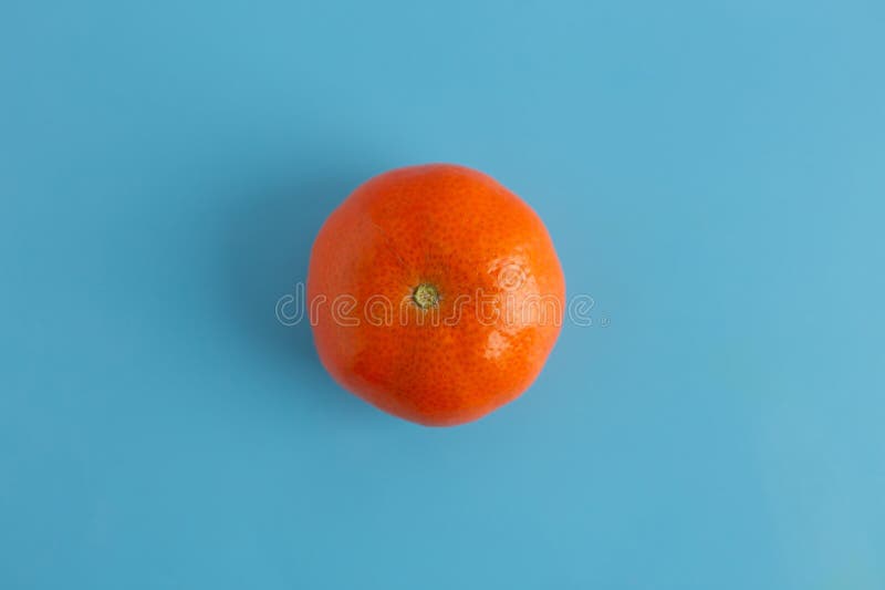 One Tangerine Sitting on Top of a Blue Table, Top View Stock Photo ...