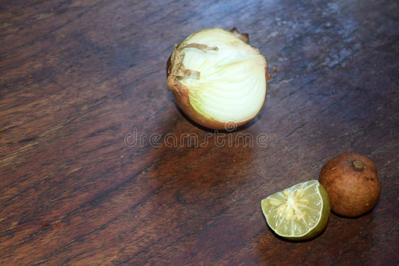 A Third of an Onion, Half a Green Lime, and a Brown Lime Stock Photo ...