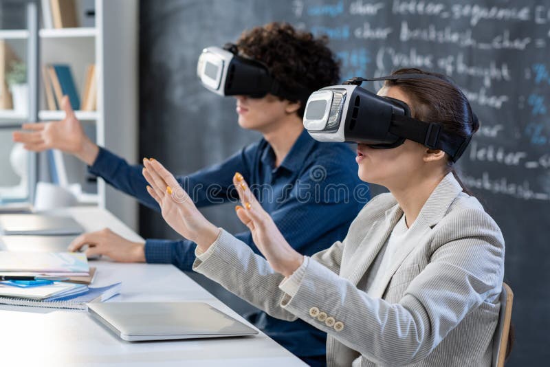 One of Two Students in Vr Headsets Touching Virtual Display during ...