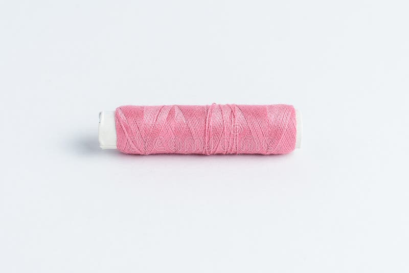 One Vivid Pink Cotton Spool of Thread Isolated on a White Table Stock ...