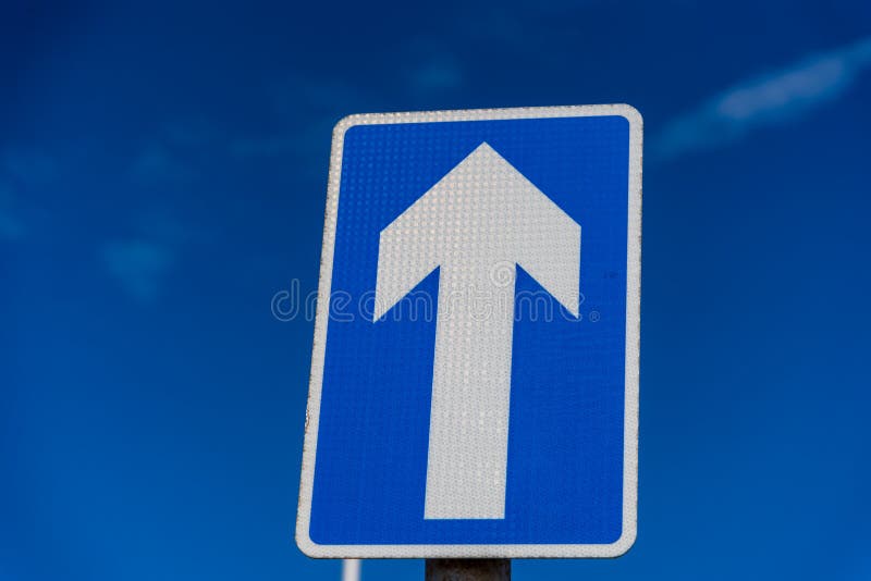 One Way Sign Set Against a Blue Sky Stock Image - Image of isolated ...
