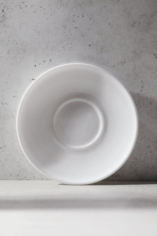 One White Ceramic Saucer on the Table with an Abstract Pattern Stock ...