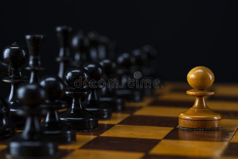 One White Pawn Against an Army of Black Pieces on a Chessboard Stock ...