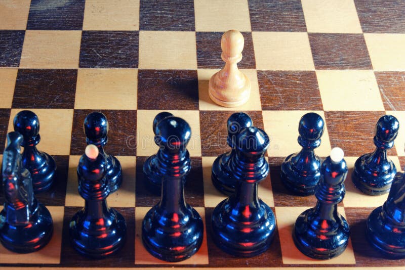 One White Pawn Against Black Chess Pieces on the Chessboard Stock Photo ...
