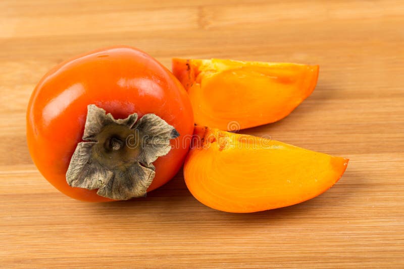 One Whole One Cut Persimmon Stock Photo - Image of healthy, orange ...