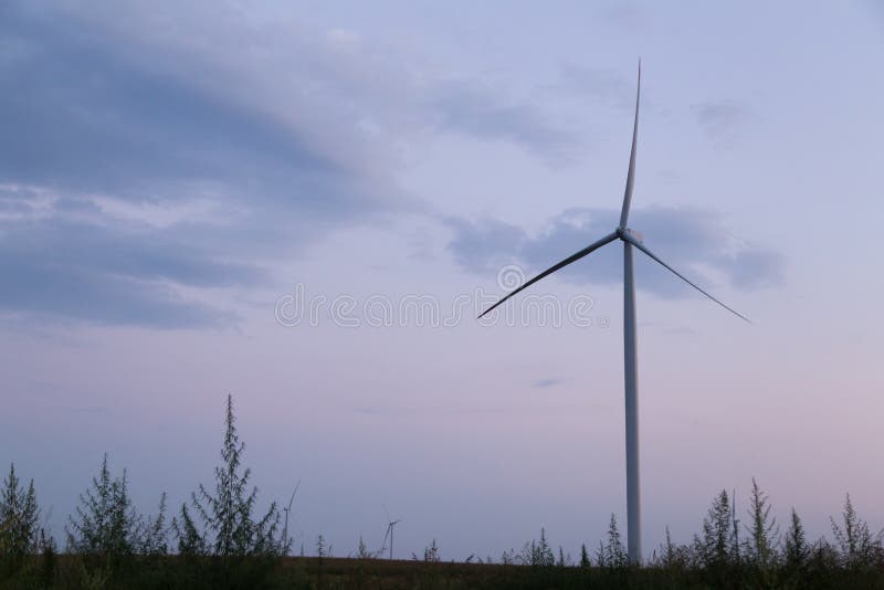 One Windmill Turbine at Blue and Purple Cloudy Sunset Sky Stock Photo ...