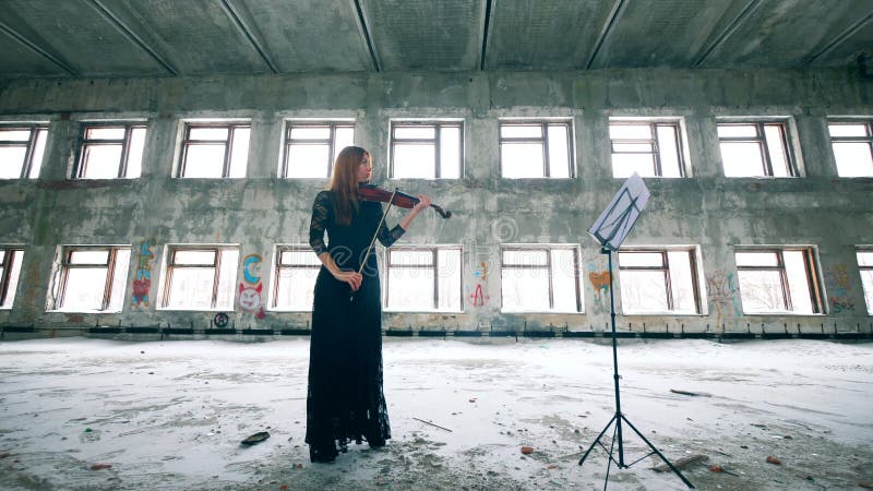 One Woman Plays Violin by Notes in Ruined Building. Stock Footage ...
