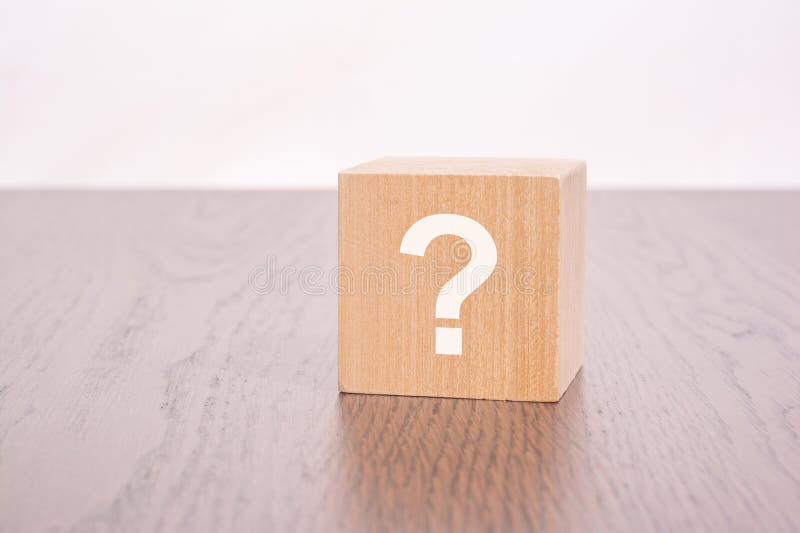 One Wooden Block with Question Mark Over a White Background with Copy ...