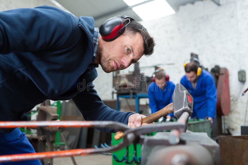 One Worker in Factory with Hammer on Work Bench Stock Image - Image of ...
