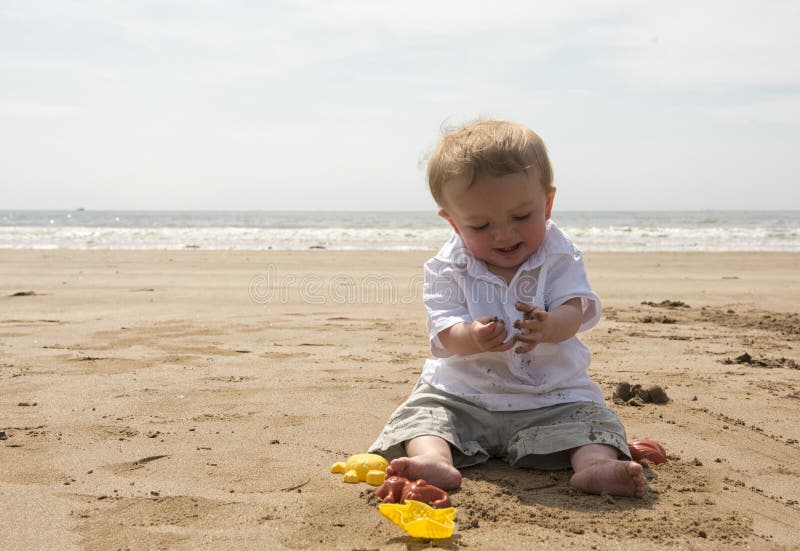 One Year Old Baby Boy Playing with Sand on the Beach Stock Photo ...