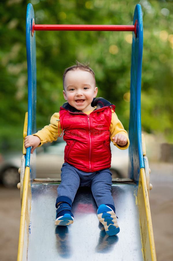 One-year-old Boy Plays on a Playground Next To a Slide. Stock Image ...