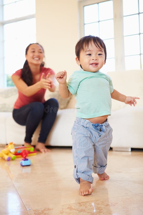 One Year Old Boy Taking First Steps with Mother Stock Photo - Image of ...