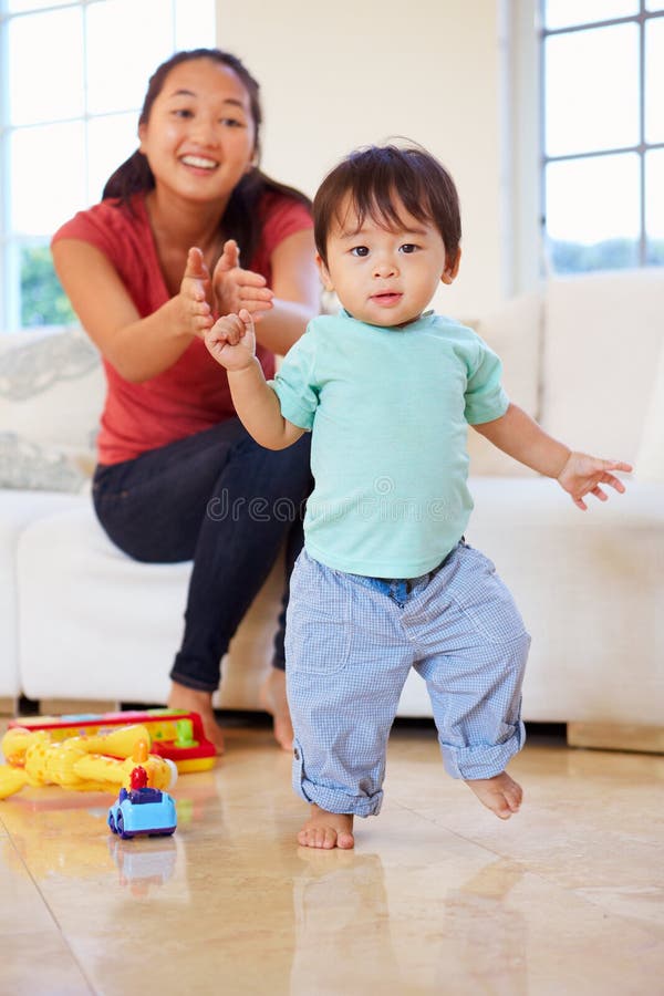 One Year Old Boy Taking First Steps With Mother Stock Image - Image of ...