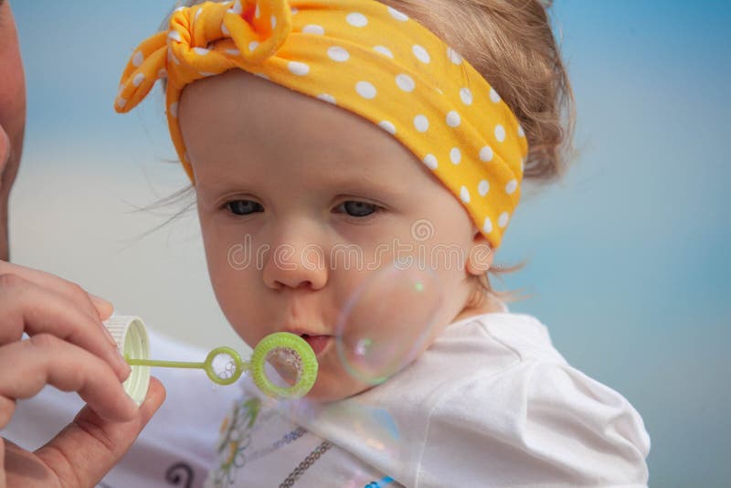 One Year Old Girl Blowing Soap Bubbles Stock Photo - Image of daughter ...