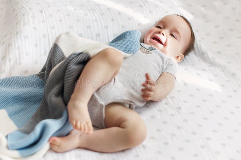 One-year-old Kid is Playing on the Bed. Stock Photo - Image of ...
