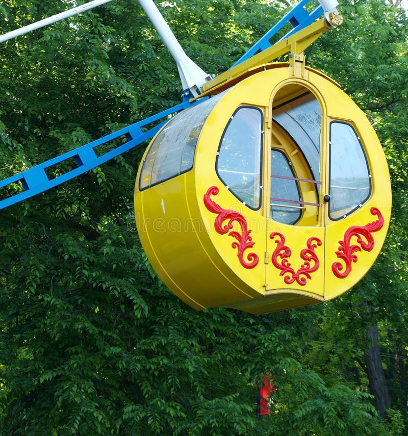 One Yellow Cubicle on Ferris Wheel Stock Image - Image of color, green ...