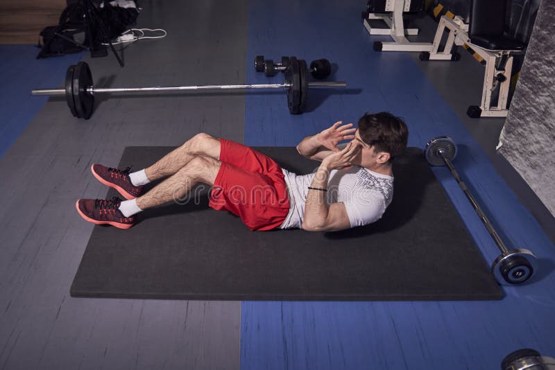 One Young Man, Abs Exercise, Laying on Floor Mat, Gym Indoors Stock ...