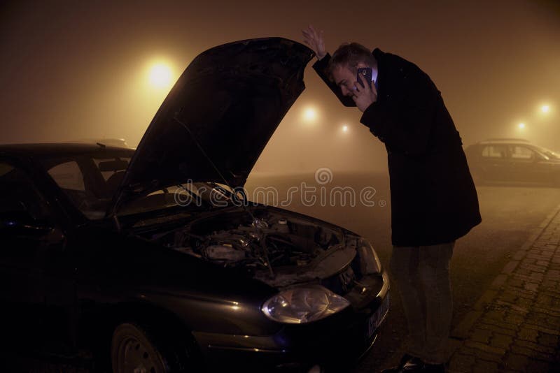 One Young Man, at Dark Night, Looking at Car Engine, with Car Hood Open ...