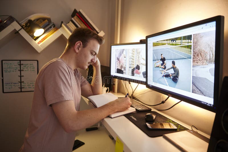 One Young Man, at His Desk in His Room, Writing in a Notebook ...